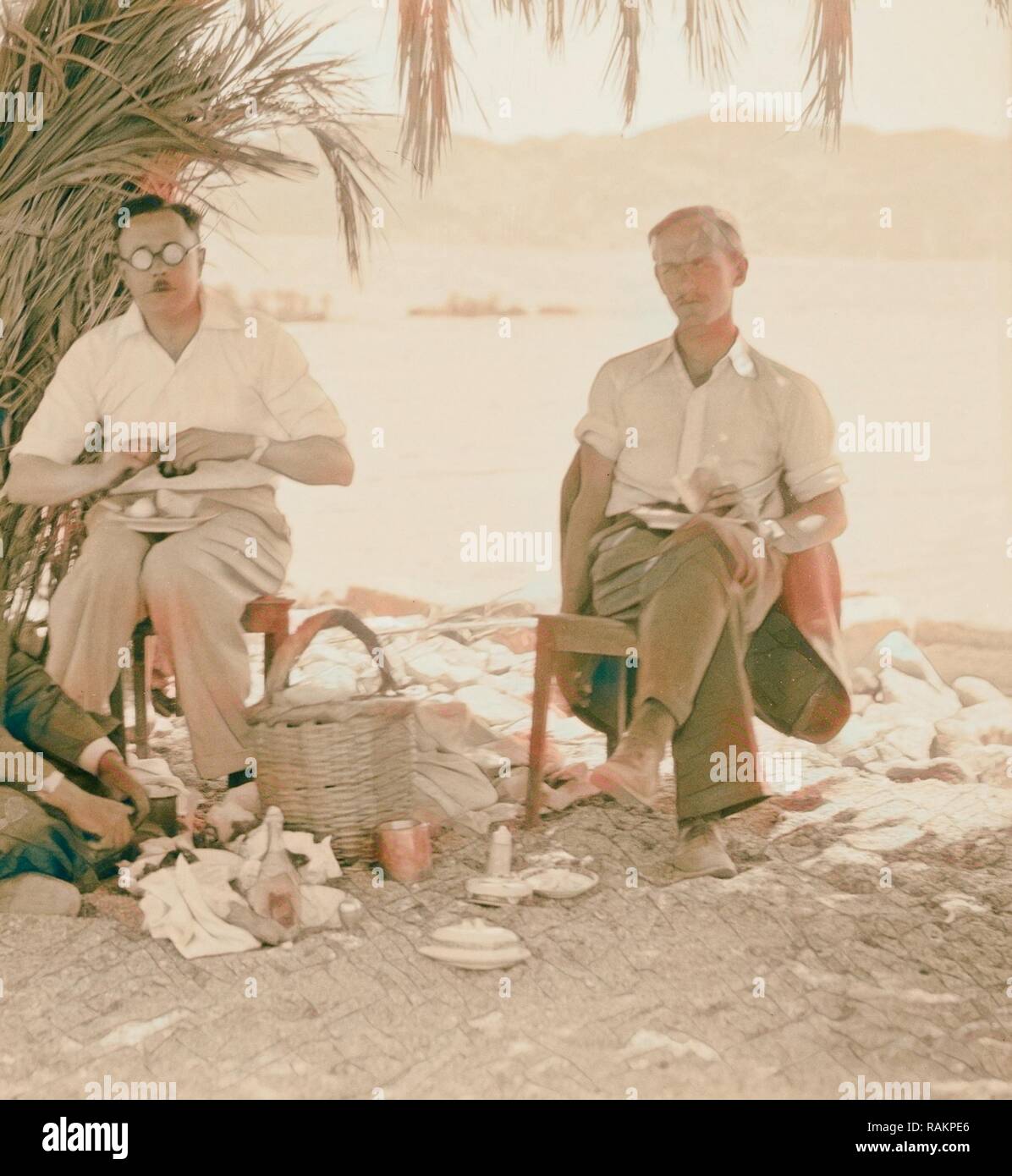 Camp at Petra. Photograh shows David Whiting with two other men, eating ...