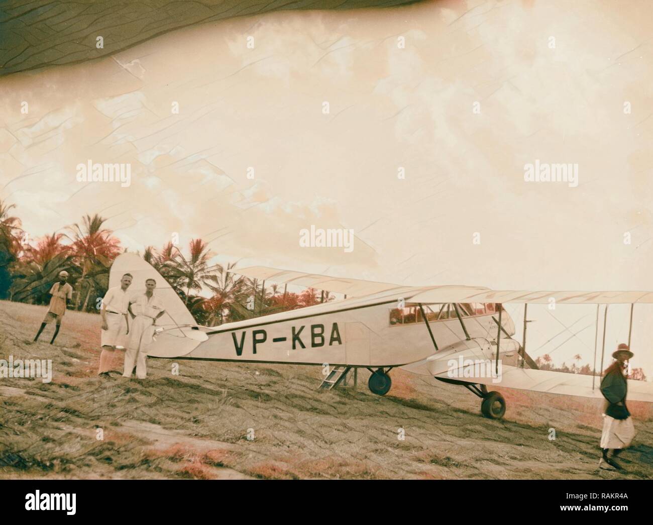 Zanzibar. 1936, Tanzania. People standing around a plane with palm ...