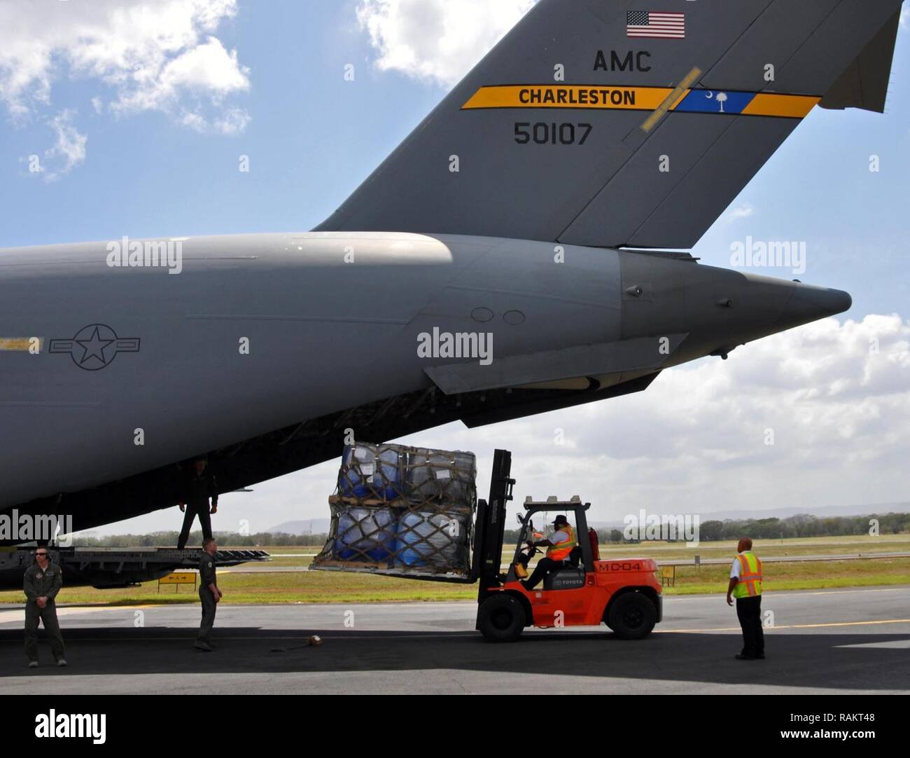 Palletized humanitarian aid cargo is offloaded from a Joint Base ...