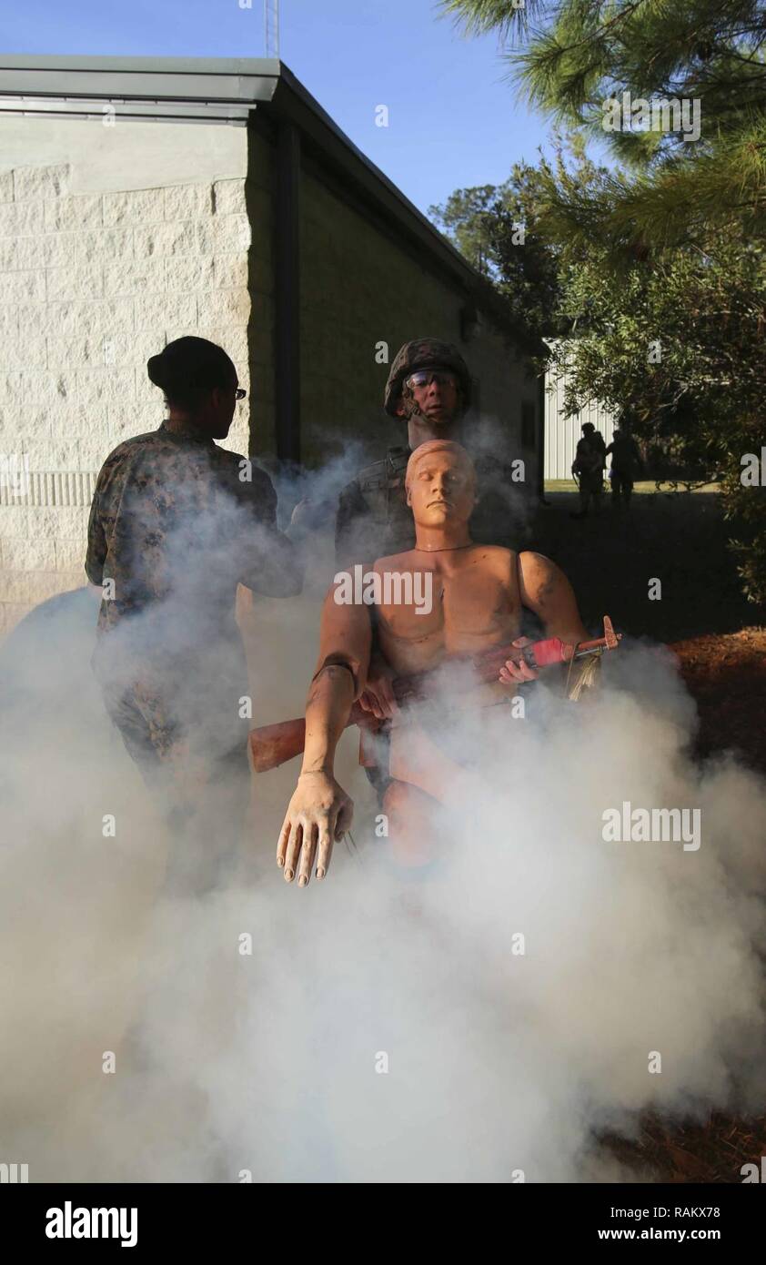 Corpsmen transport a notional patient onto an aircraft during a ...