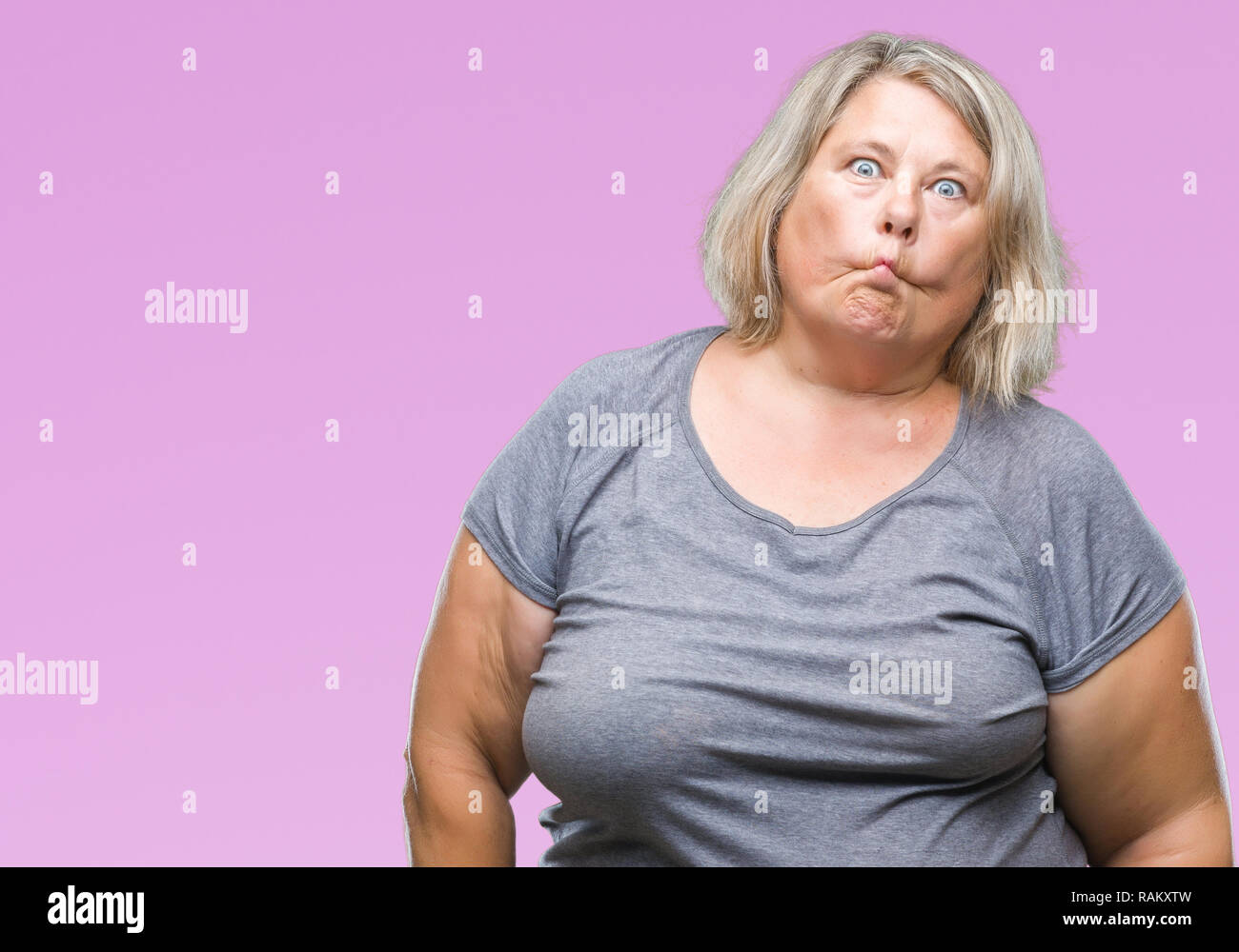 Senior plus size caucasian woman over isolated background making fish ...