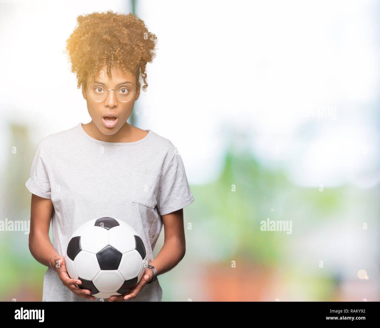Young african american woman holding soccer football ball over isolated ...