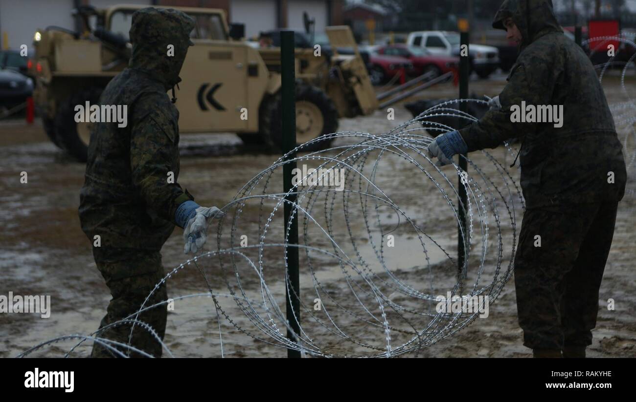 Marines with Combat Logistics Regiment 25 set up concertina wire to ...
