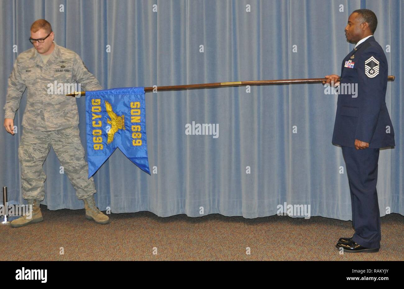 The 689th Network Operations Squadron’s guidon is unfurled during an ...