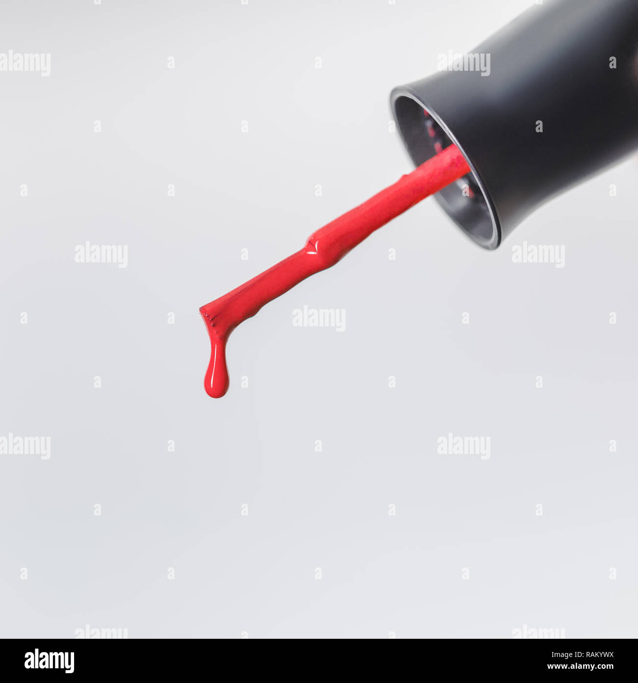close up view of brush with dripping red nail polish drop isolated on ...