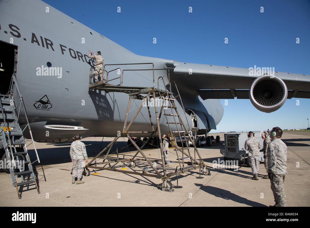 Maintainers from 349th Aircraft Maintenance Squadron place covers over ...