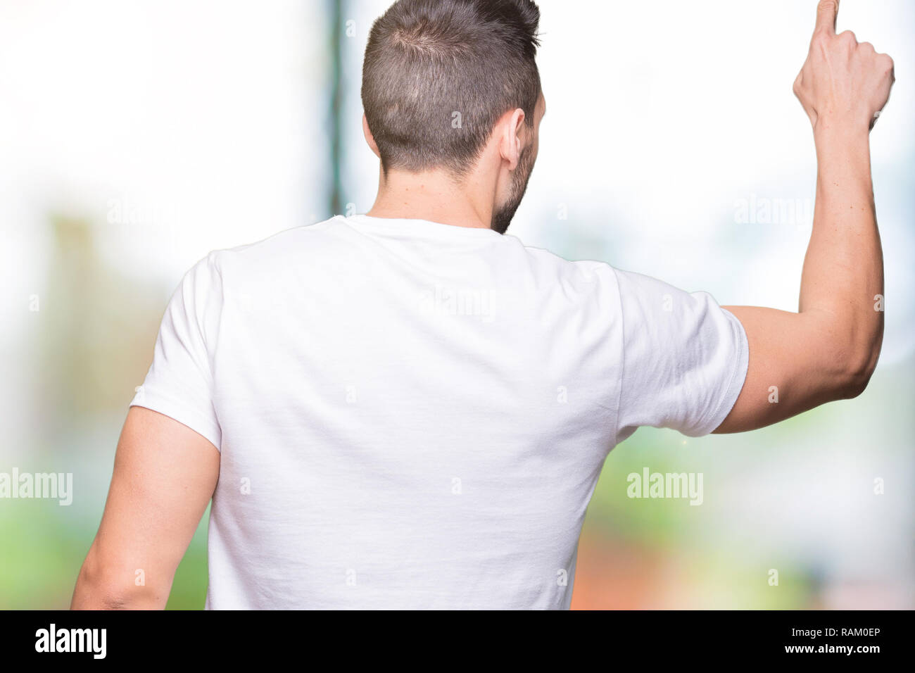 Handsome man wearing white t-shirt over outdoors background Posing ...