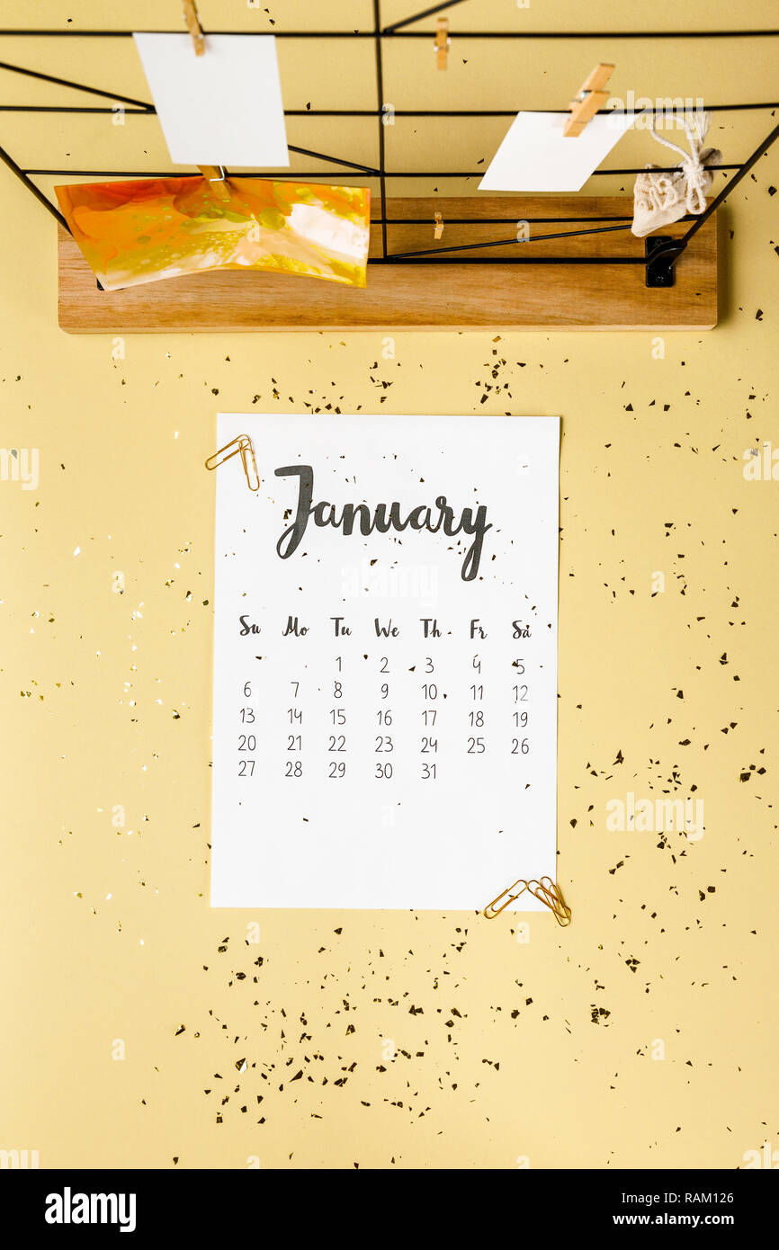top view of january calendar with golden confetti and cards with ...