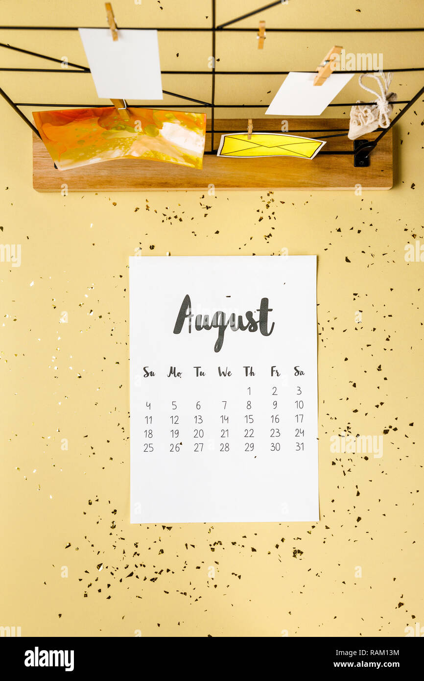 top view of august calendar with golden confetti and cards with ...