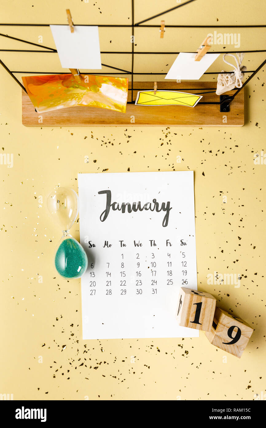 top view of january calendar with golden confetti and cards with ...