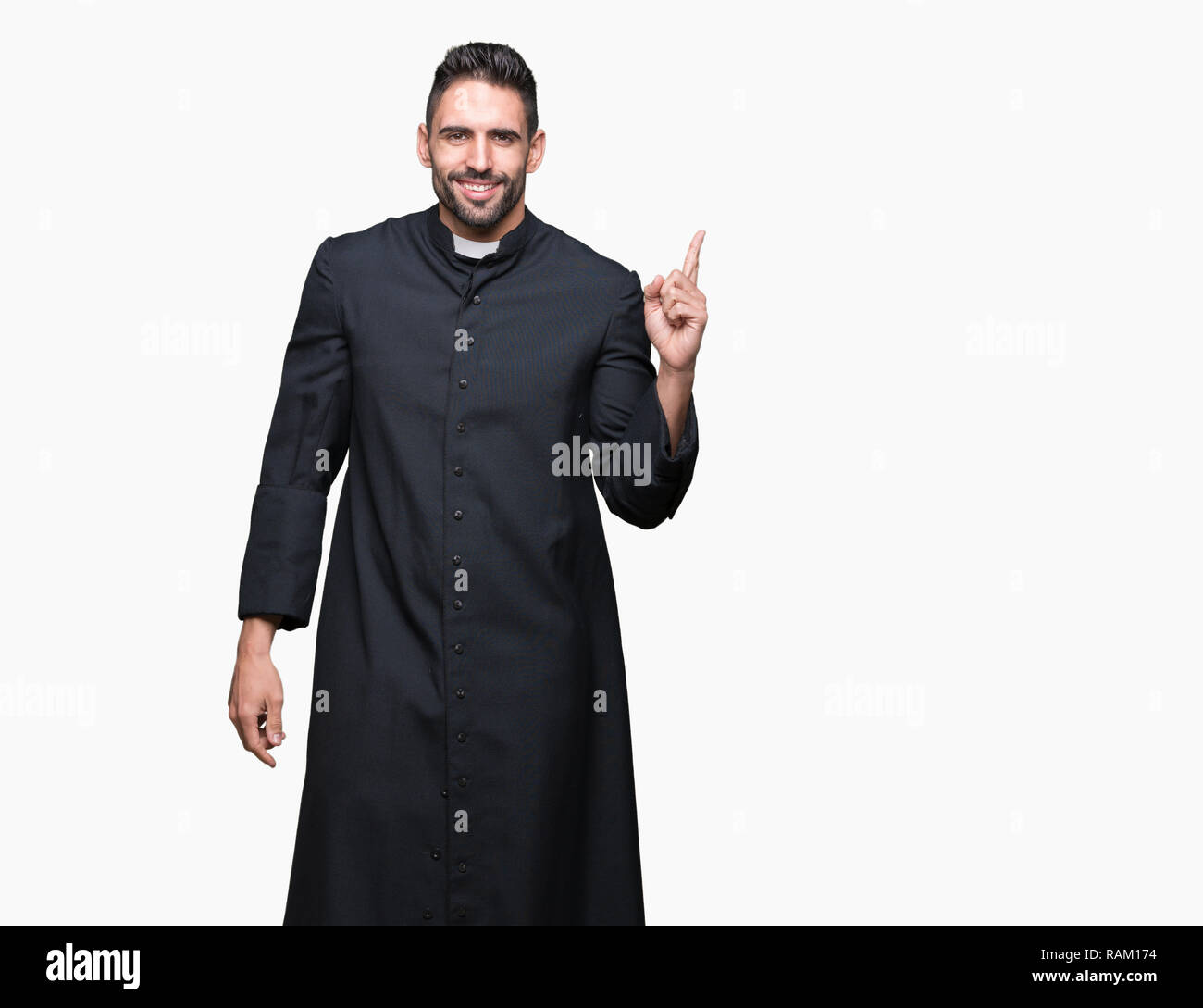 Young Christian priest over isolated background with a big smile on ...