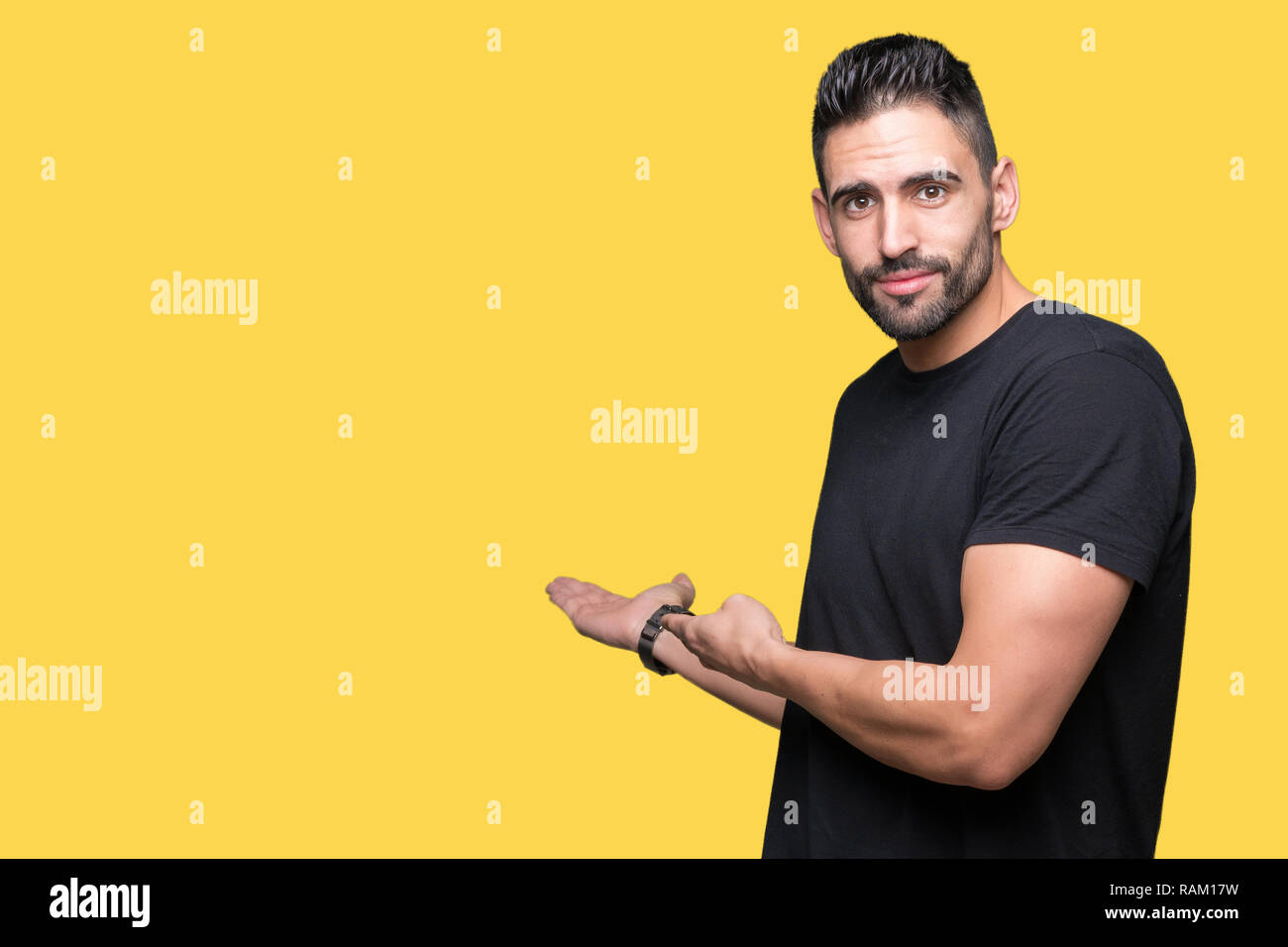 Young handsome man over isolated background Inviting to enter smiling ...