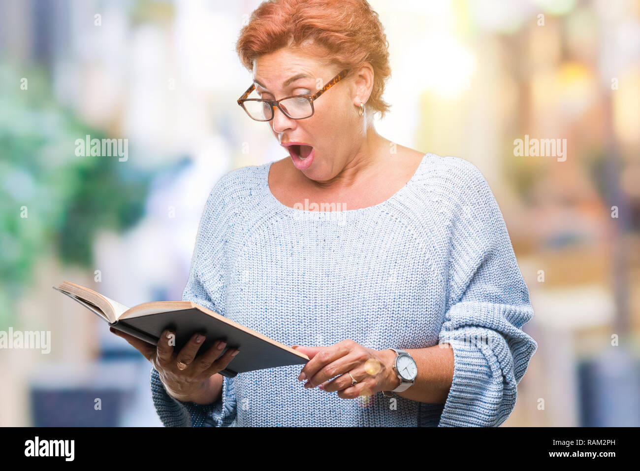 Woman shock reading book library hi-res stock photography and images ...