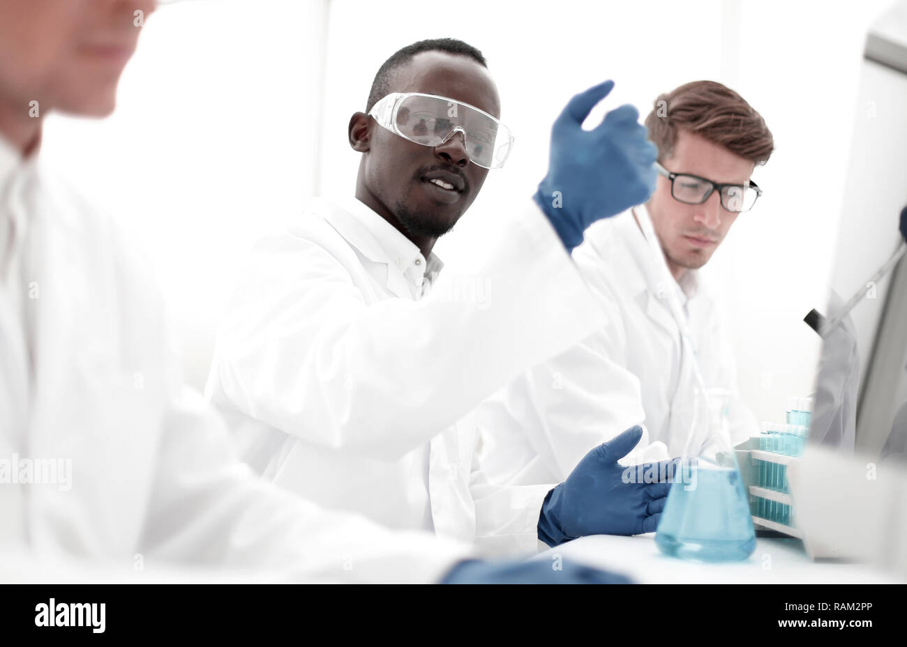 group of scientists are conducting experiments with the liquid Stock ...