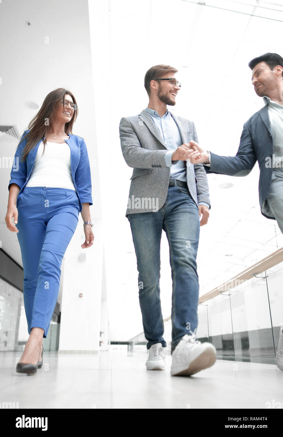 employees greet each other in the office building Stock Photo - Alamy