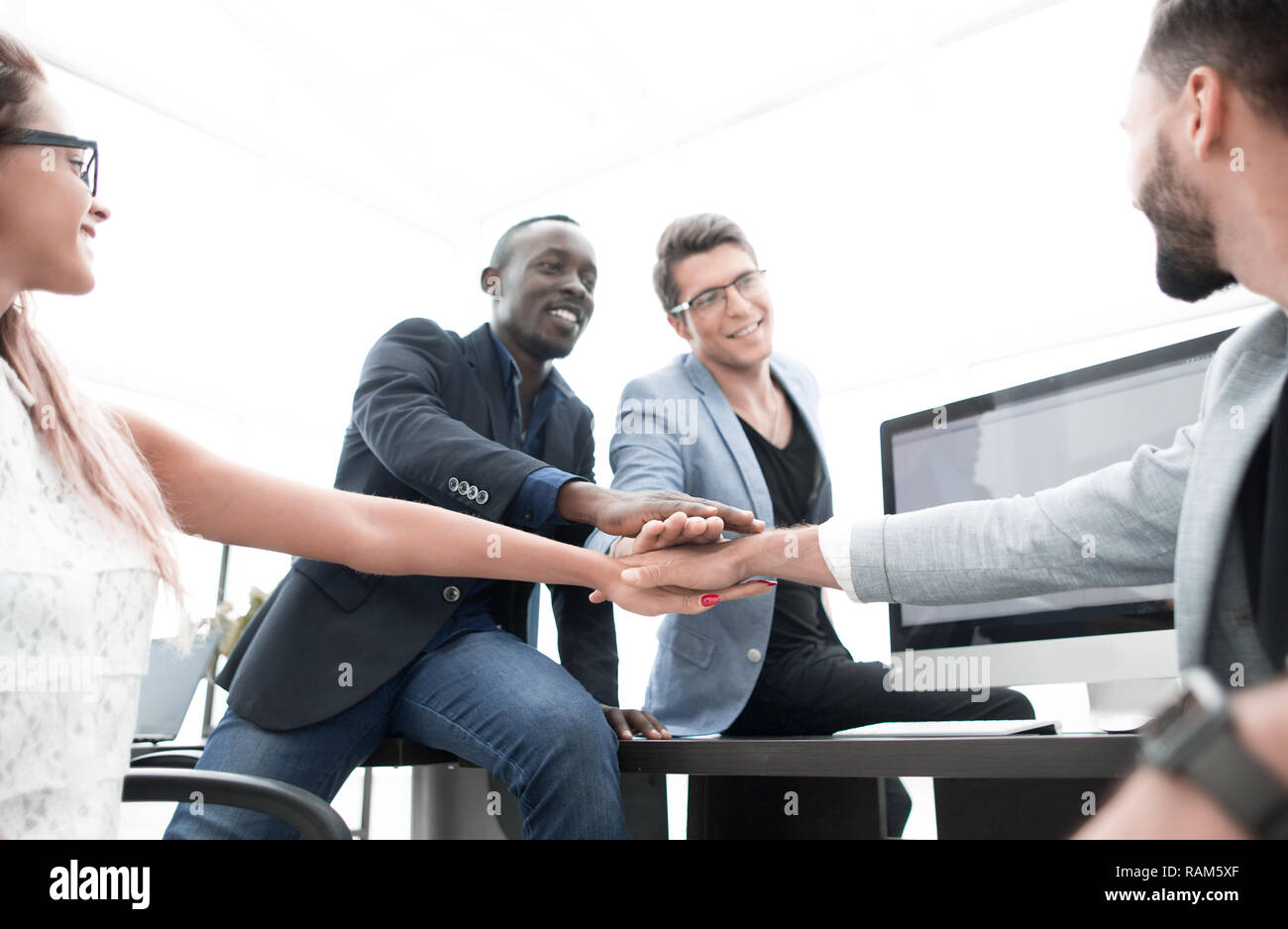 single business team with their hands folded together Stock Photo - Alamy