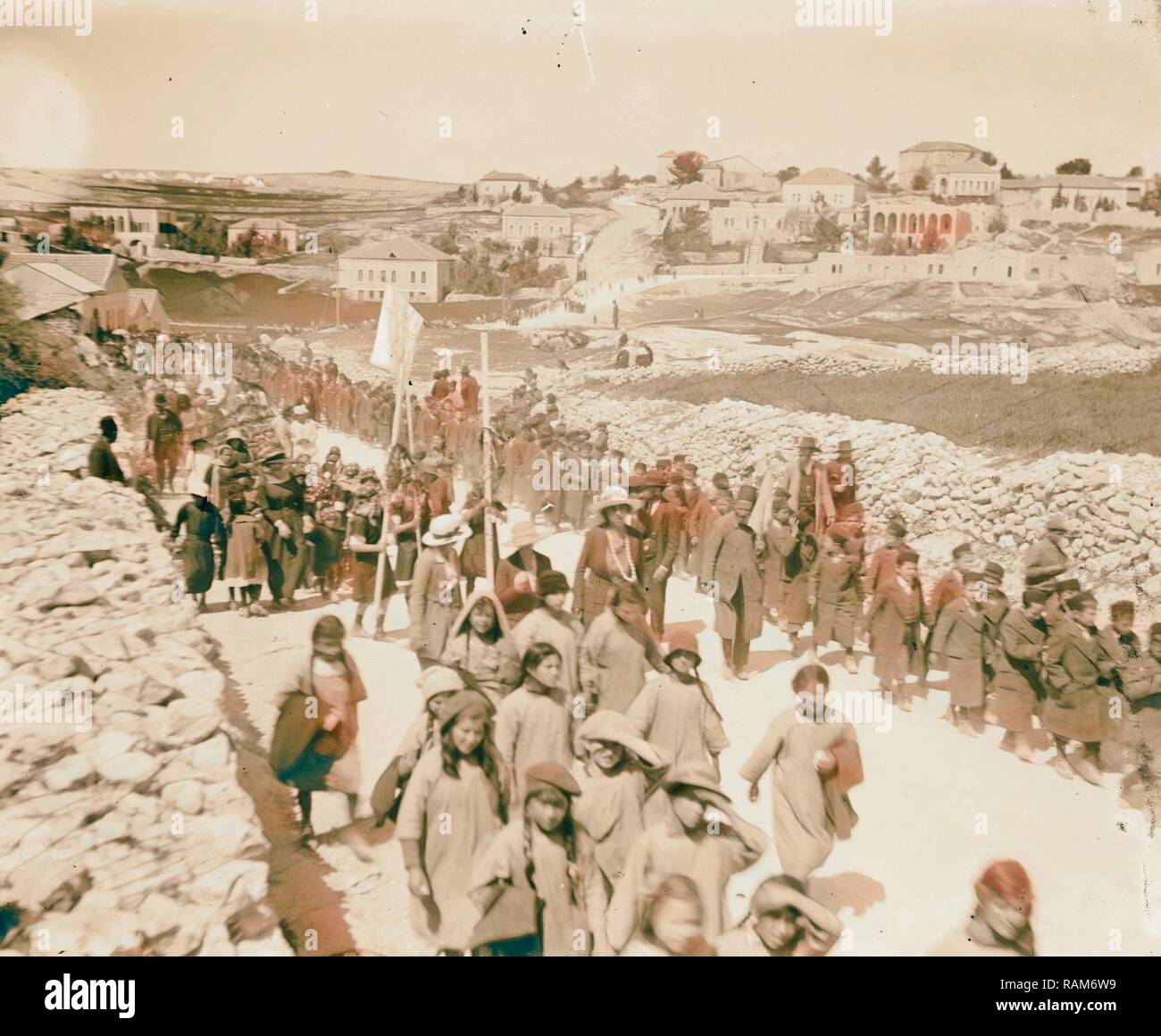 Jewish children and adults, one holding a Star of David banner, walking ...