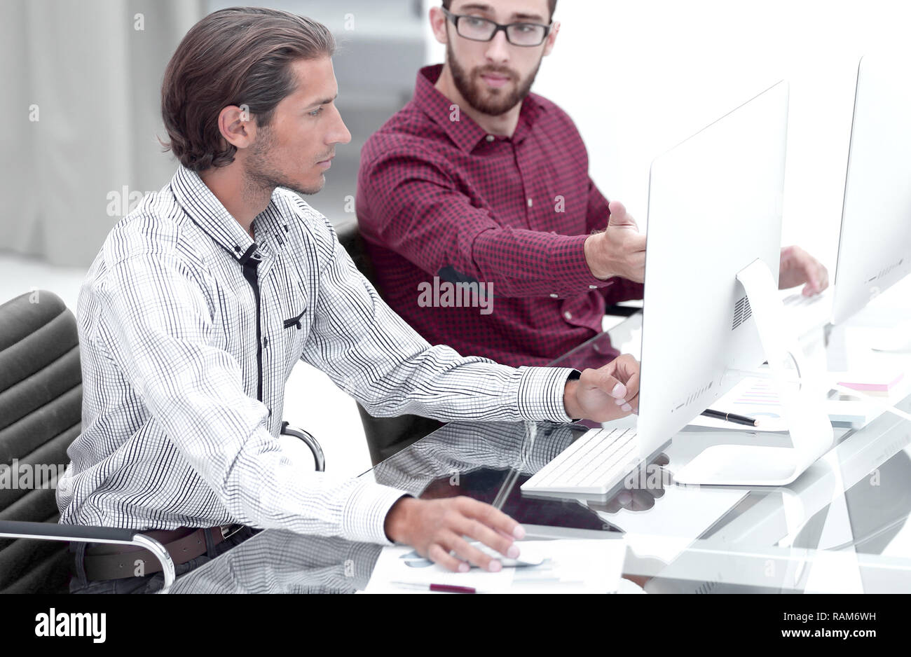 Two employees , sitting in front of computer Stock Photo - Alamy