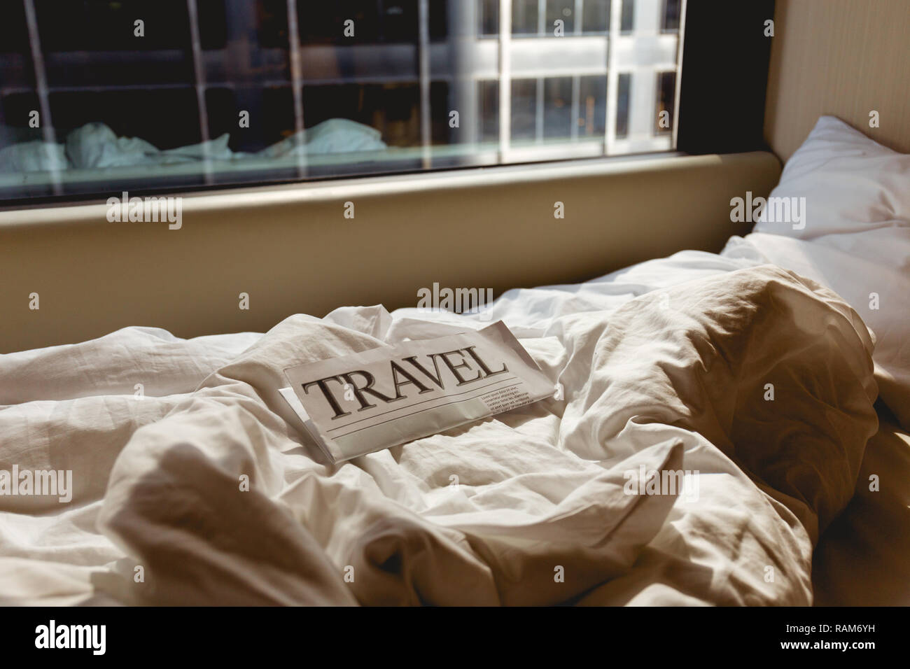close up view of travel newspaper on bed in hotel room Stock Photo - Alamy