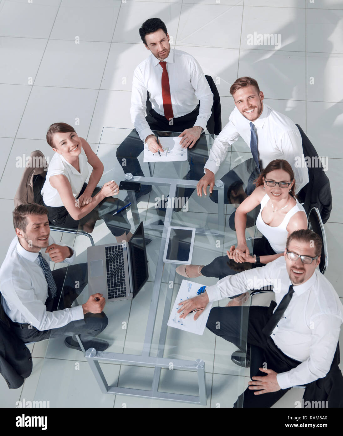 Business People Working Around a Conference Table Stock Photo - Alamy