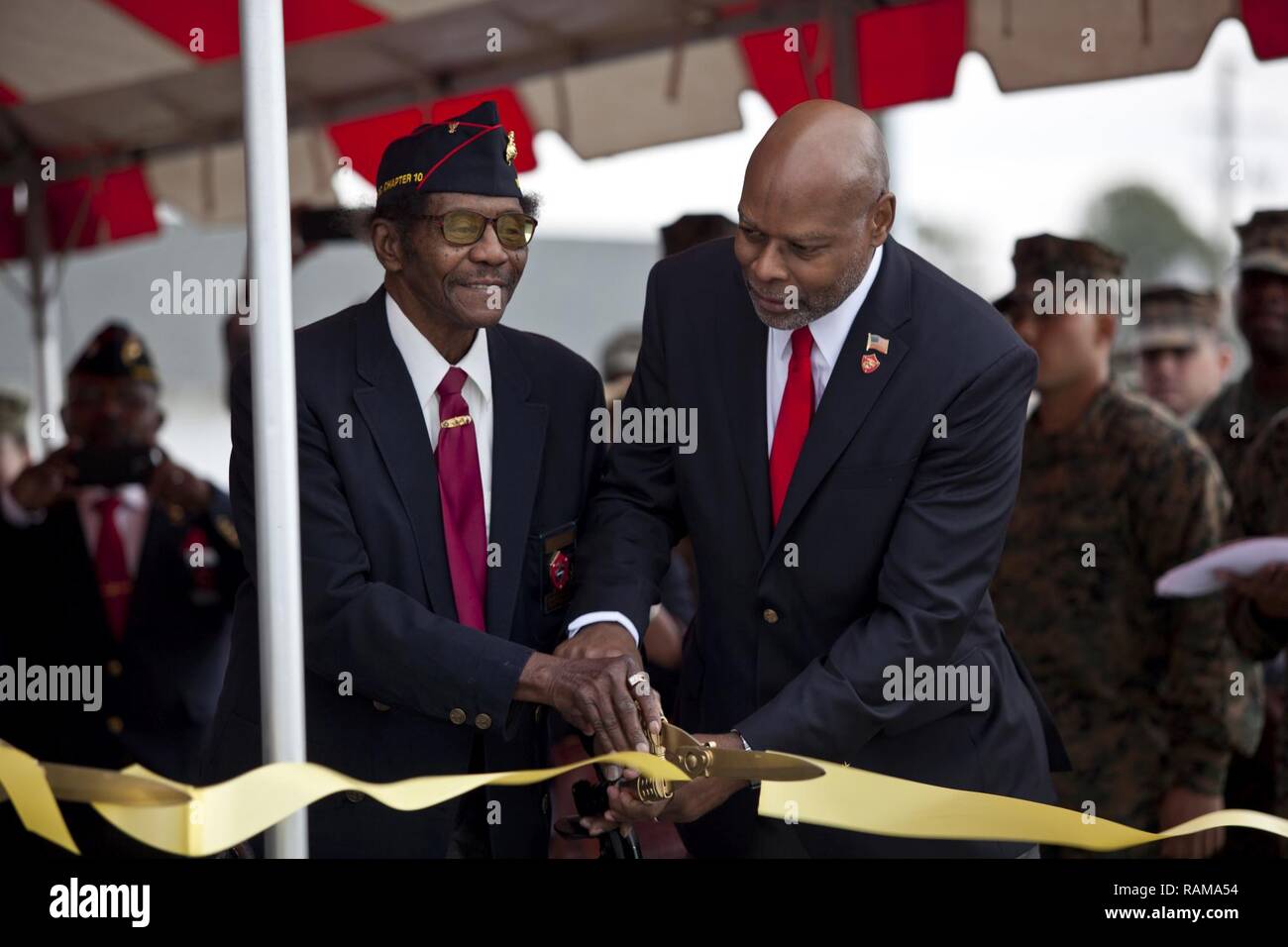 Retired U.S. Marine Corps Col. Grover C. Lewis, right, assists in ...