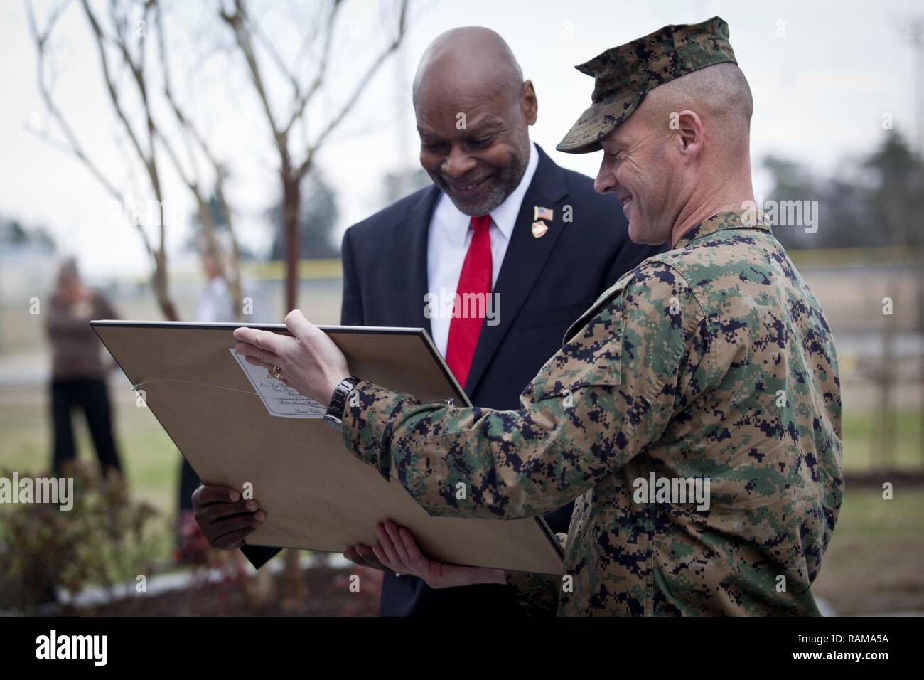 Retired U.S. Marine Corps Col. Grover C. Lewis, left, receives a gift ...
