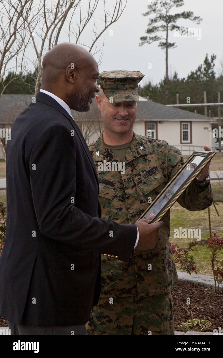 Retired U.S. Marine Corps Col. Grover C. Lewis, left, receives a gift ...