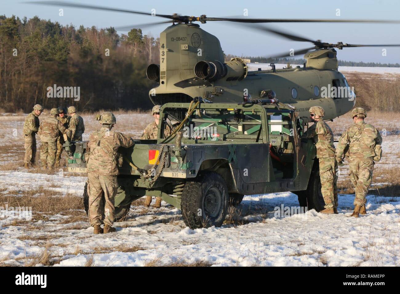 The crew chief of a CH-47, Chinook, examines the sling load inspection ...