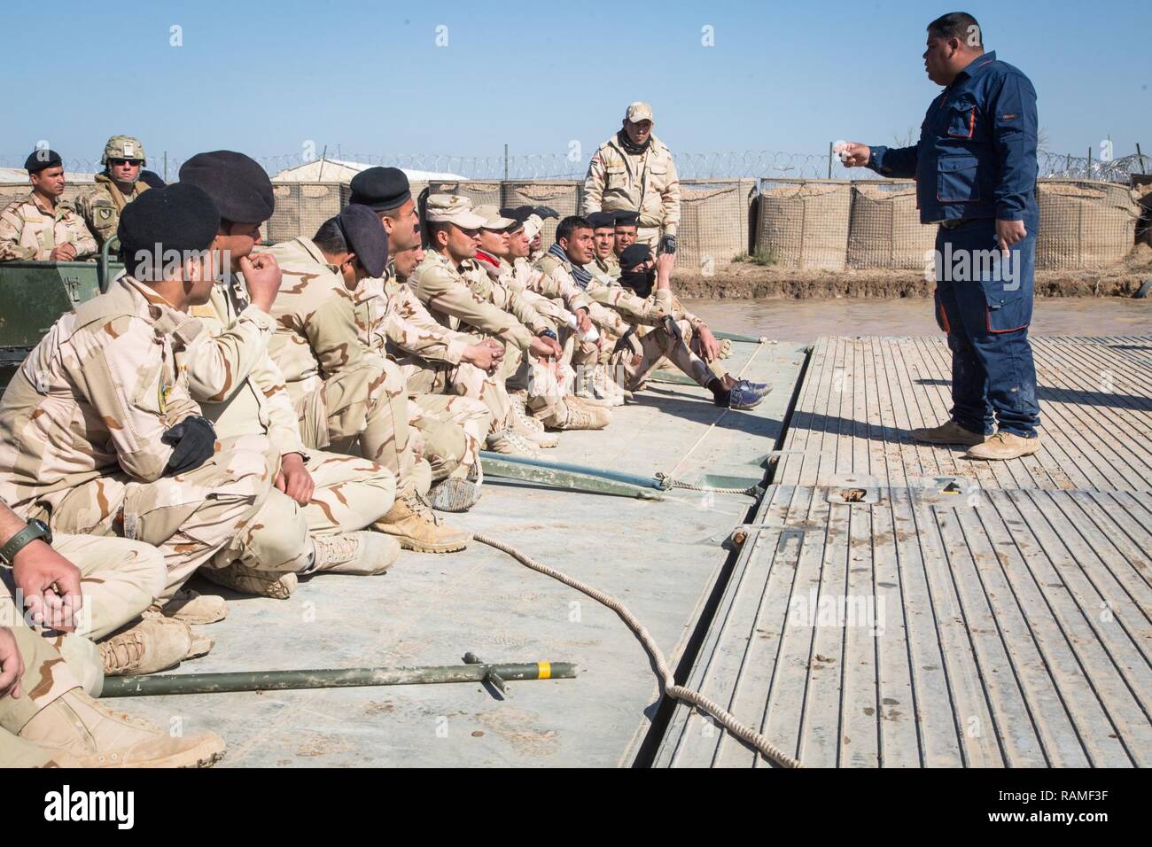 An Iraqi security forces engineer, right, instructs fellow Iraqi ...
