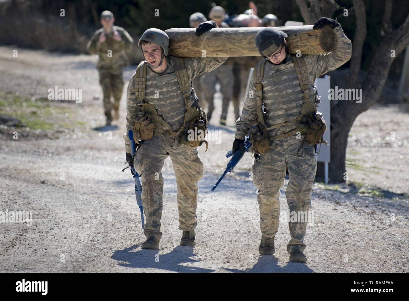 Air Force Academy cadets carry a log over their shoulders during a ...