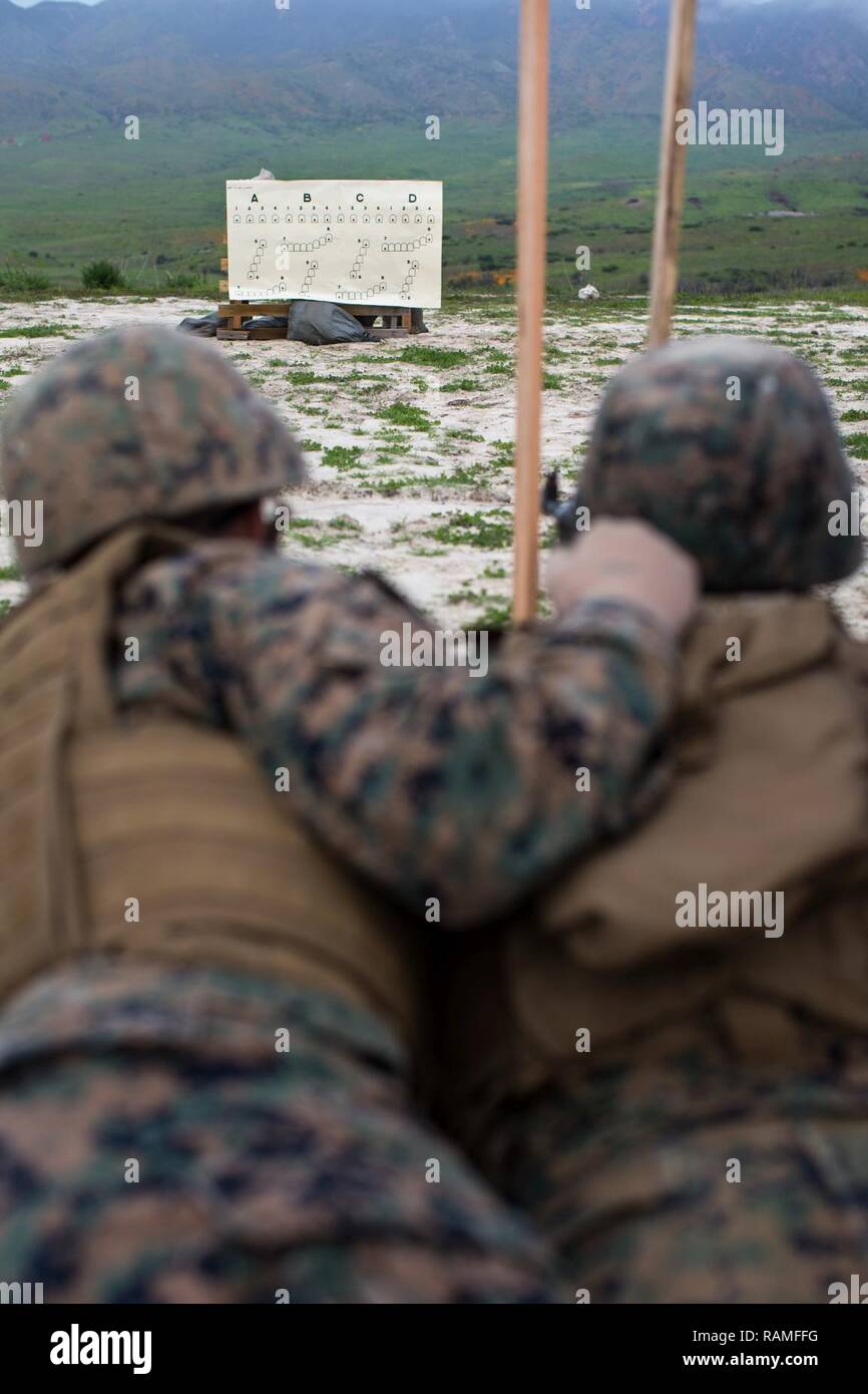 U.S. Marine Corps Lance Cpl. Felix Castro, left, assists Lance Cpl ...