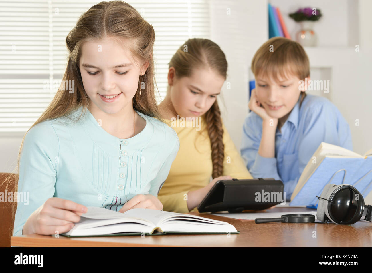 Portrait of children doing homework together at home Stock Photo - Alamy