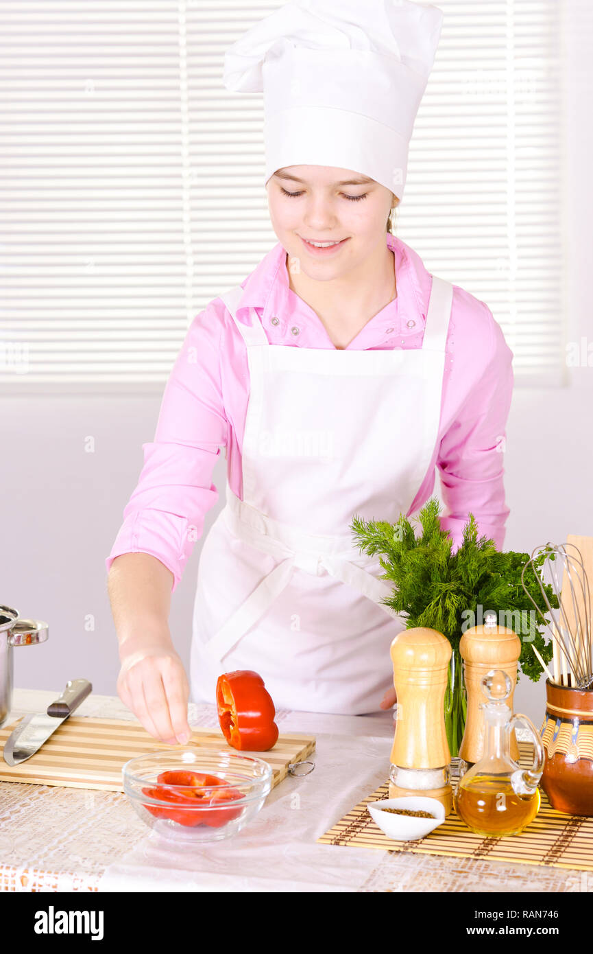 Beautiful girl wearing chef uniform with vegetables on kitchen Stock ...