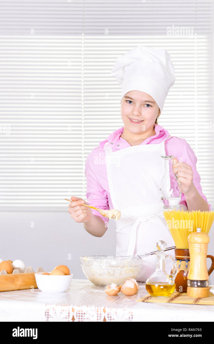 Cute girl cooking in the kitchen at home Stock Photo - Alamy