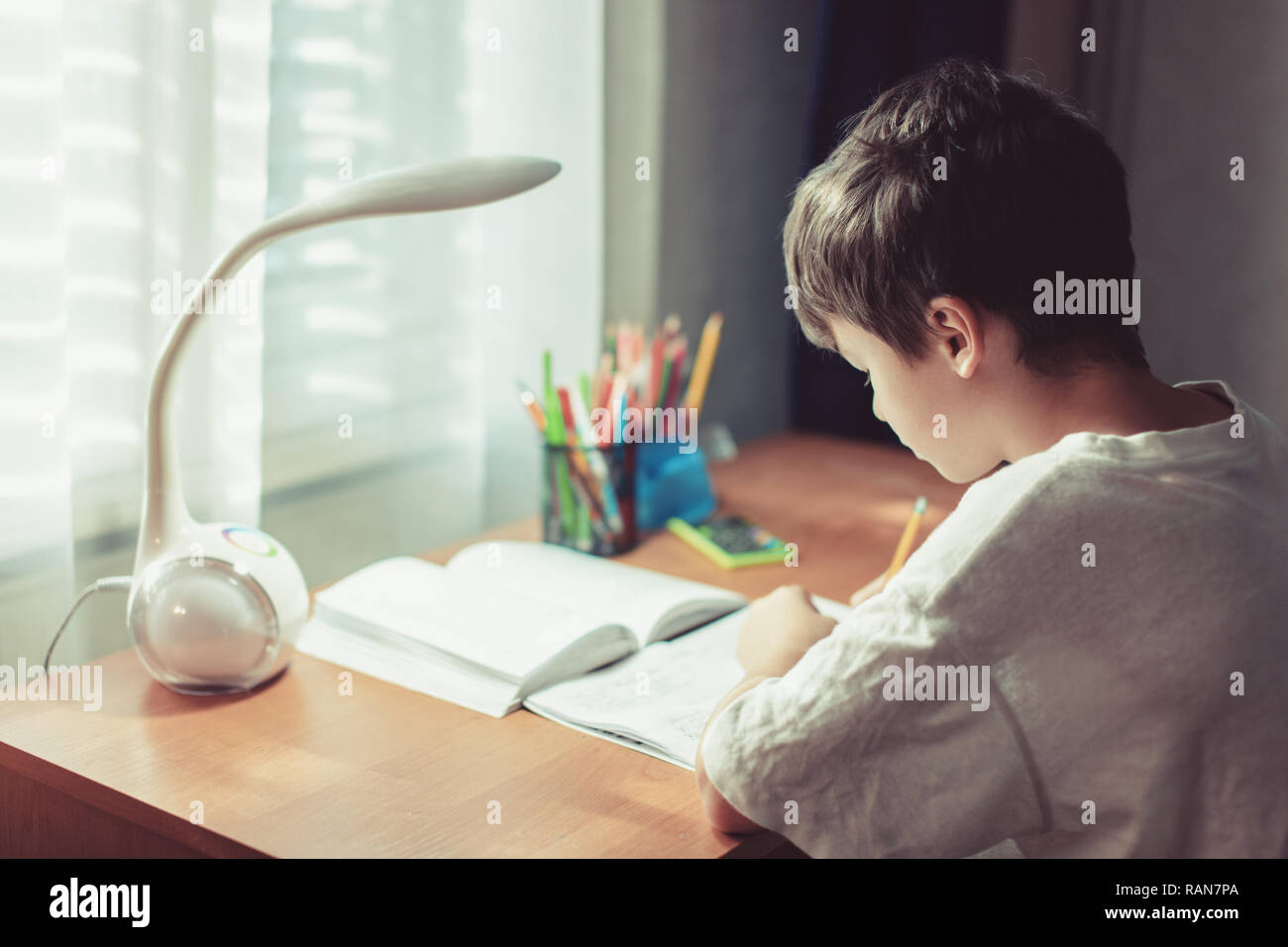 Young little kid doing homework or learning at home Stock Photo - Alamy