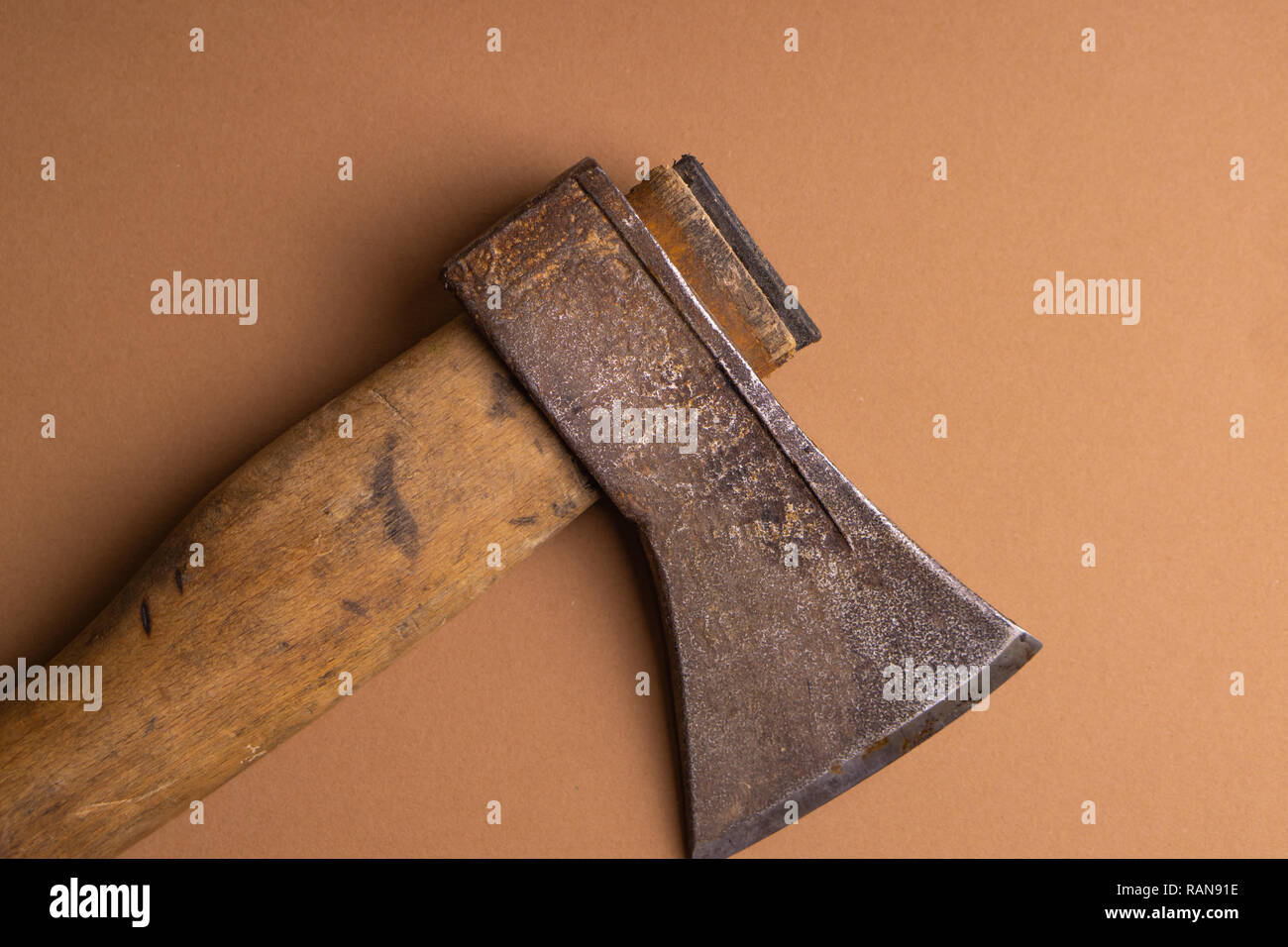 The old ax lies on the ground . Old ax with wooden handle on light ...