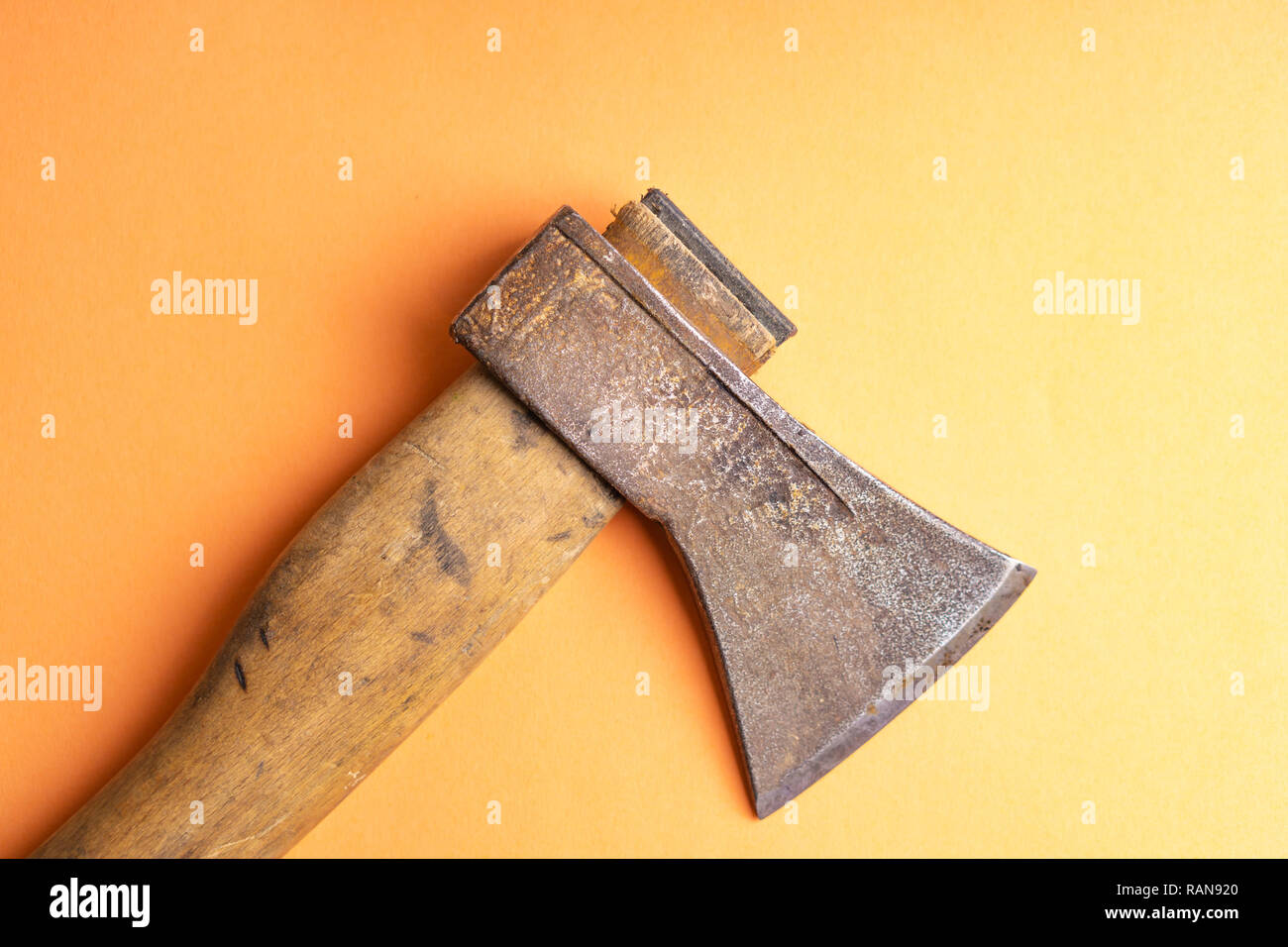 The old ax lies on the ground . Old ax with wooden handle on light ...