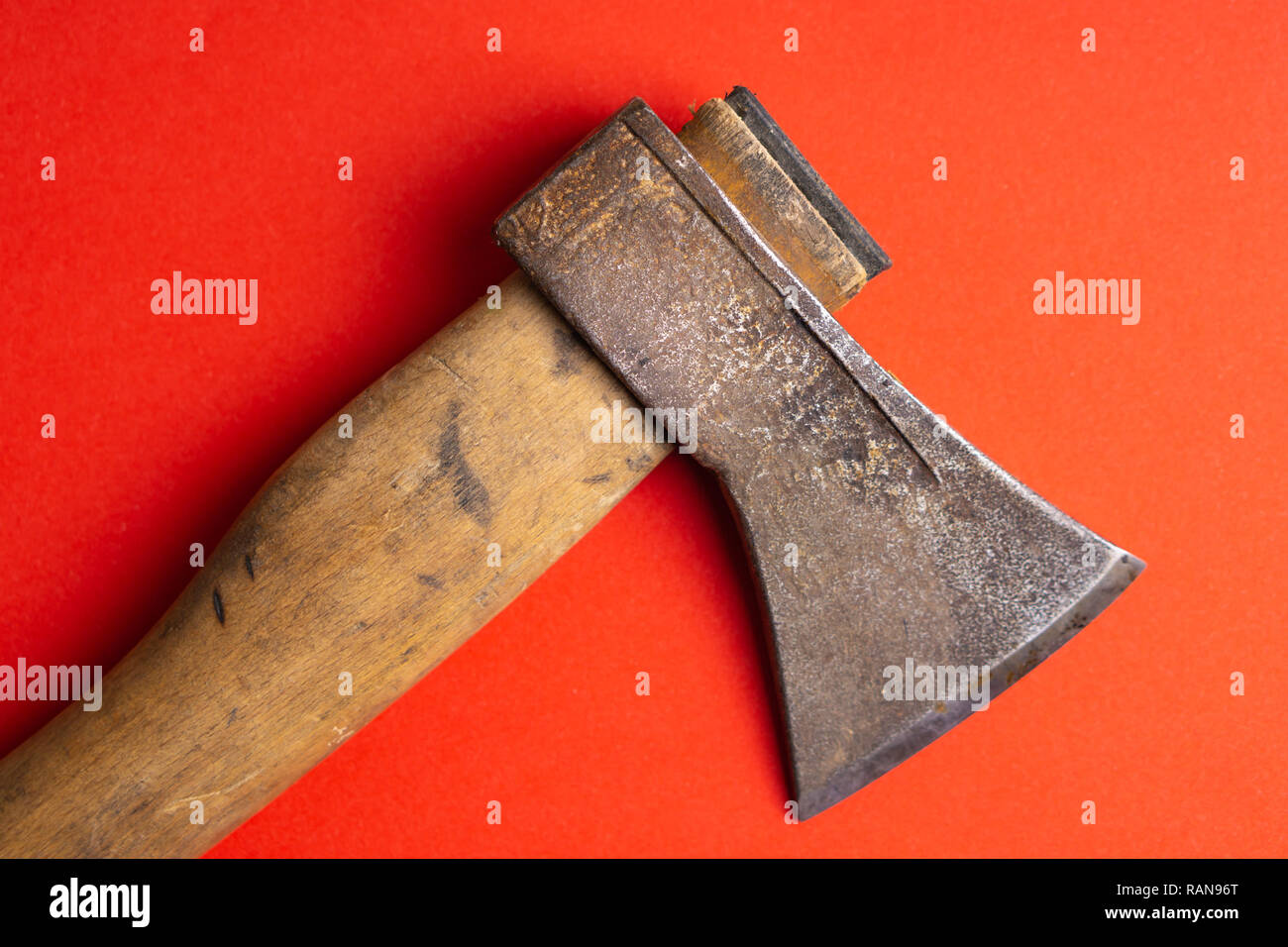 The old ax lies on the ground. Old ax with wooden handle on a bright ...