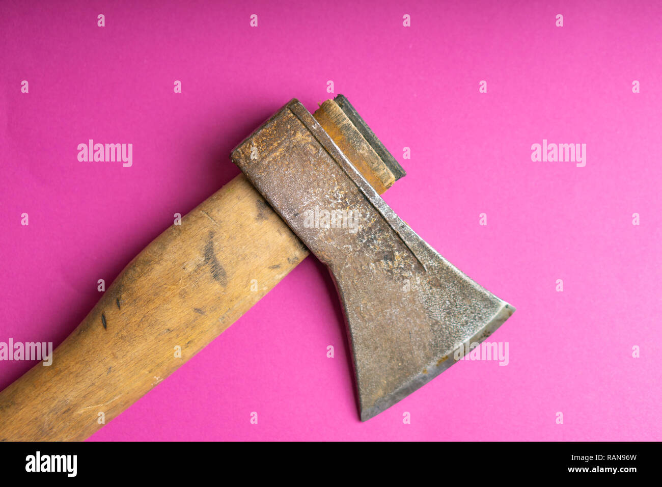 The old ax lies on the ground. Old ax with wooden handle on a bright ...