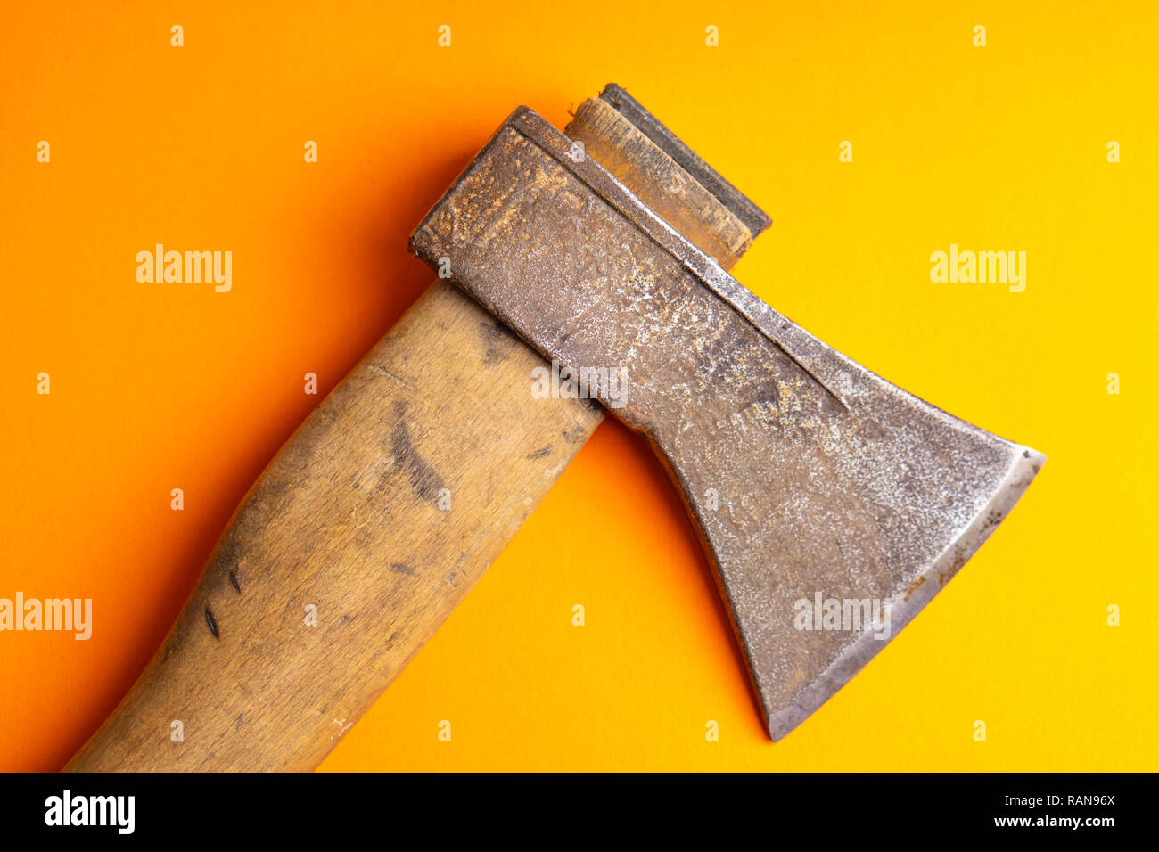 The old ax lies on the ground. Old ax with wooden handle on a bright ...