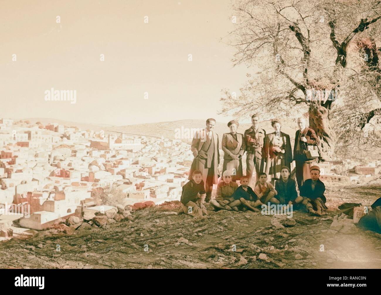 Eric Matson with camera case (standing far right) with adults and Arab ...