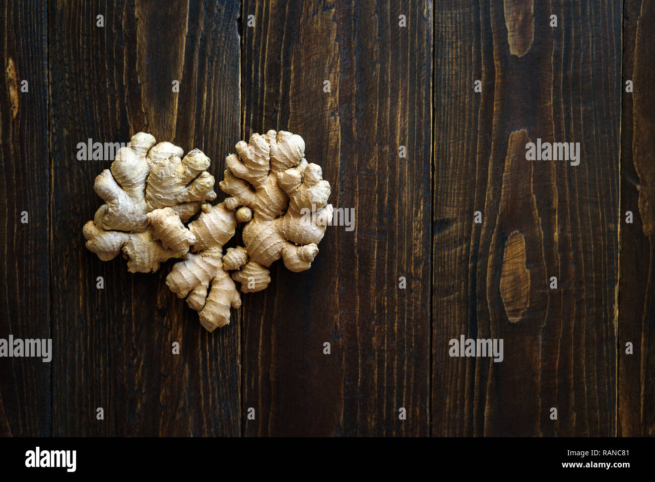 Heart shaped ginger roots on dark wooden background Stock Photo - Alamy