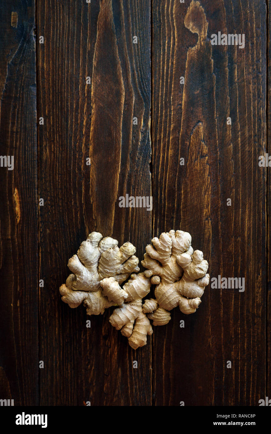 Heart shaped ginger roots on dark wooden background Stock Photo - Alamy