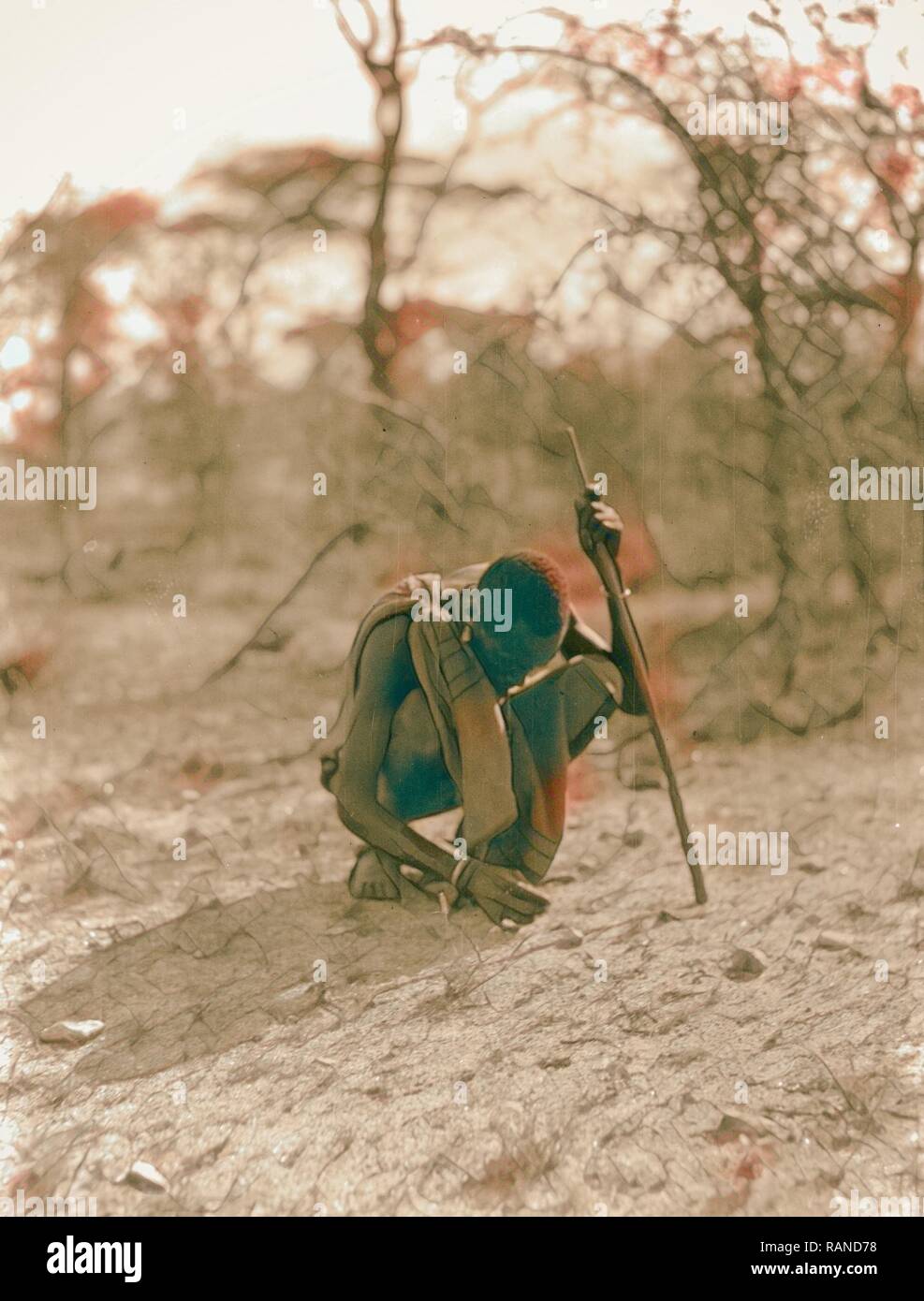 Kenya Colony. Namanga, southern game reserve. Native tracker studying ...