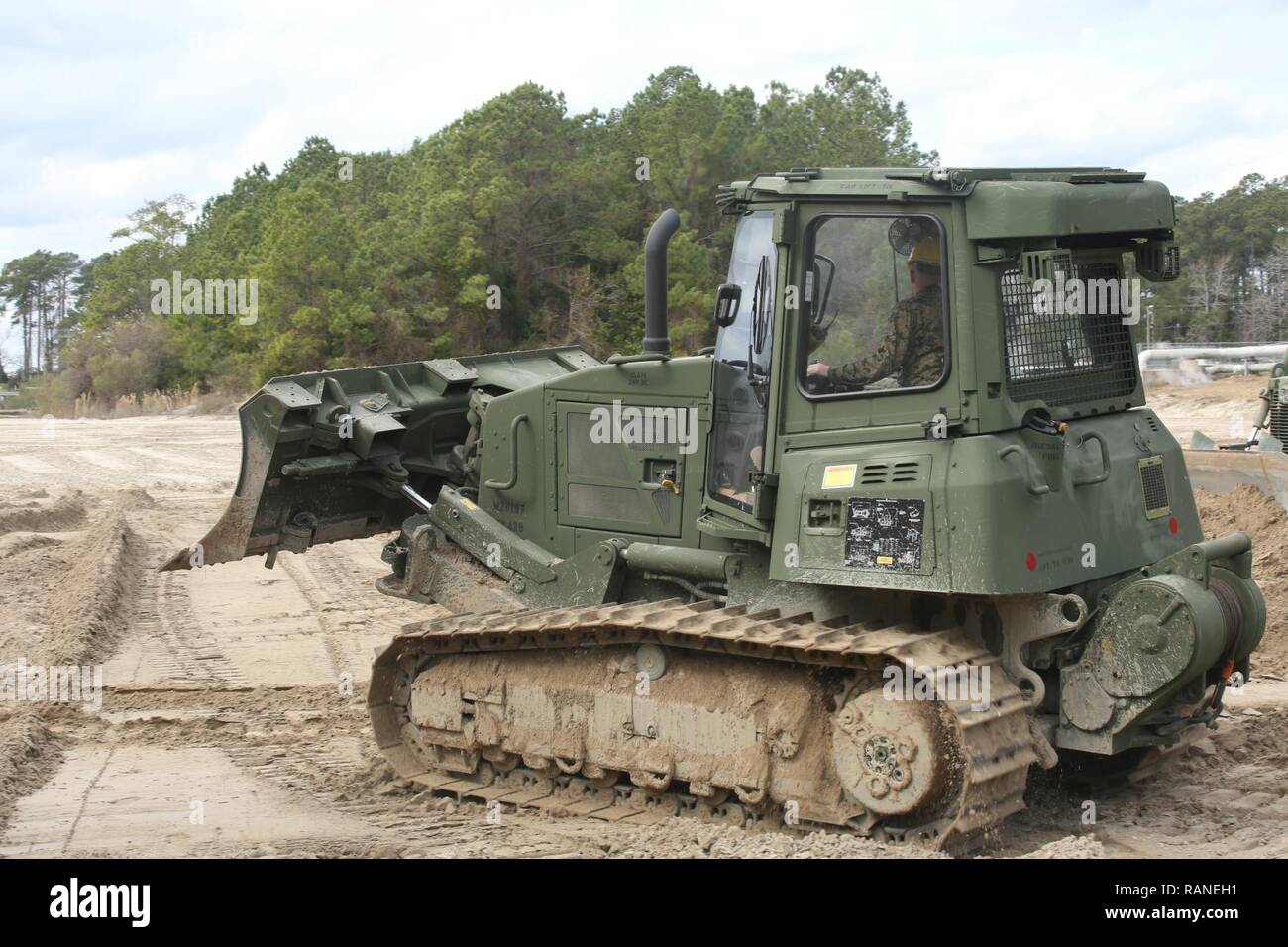 A Marine with Combat Logistics Battalion 22 drives a bulldozer to begin ...
