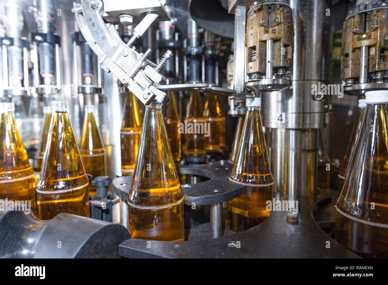 Bottles on the conveyor of the bottling plant in a factory. Attach the ...
