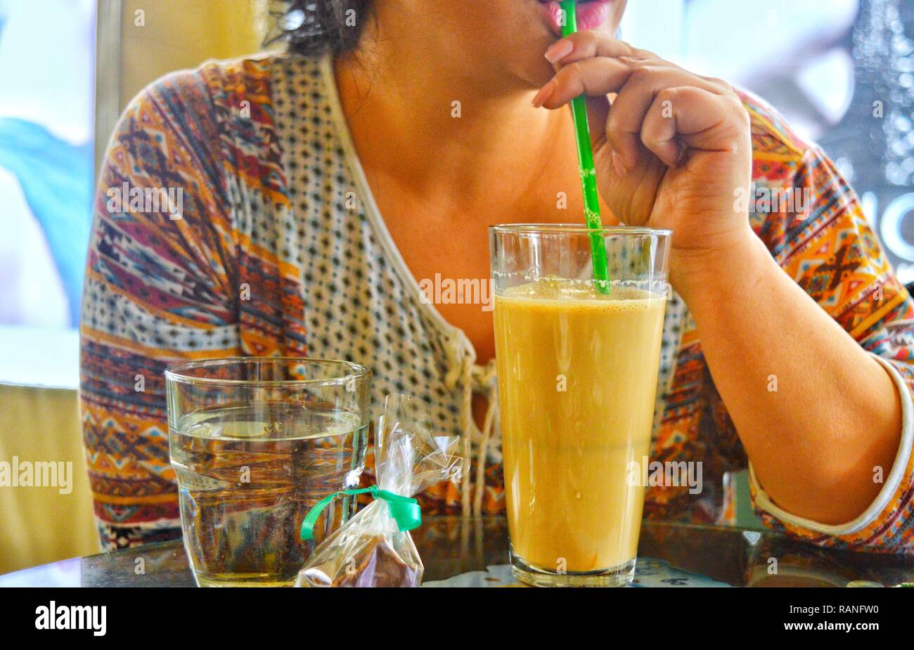 A person drinking coffee at a bar Stock Photo - Alamy