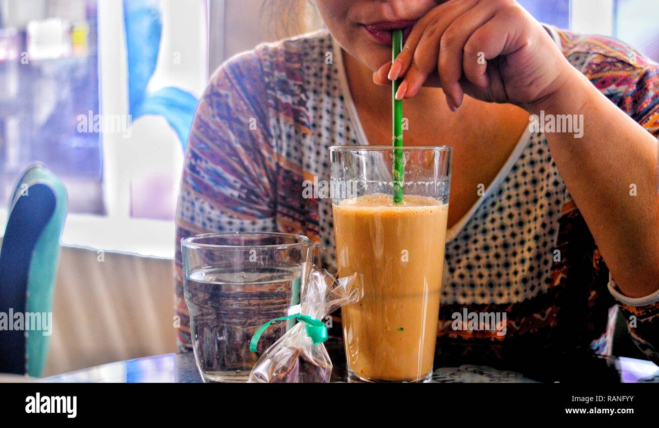 A person drinking coffee at a bar Stock Photo - Alamy