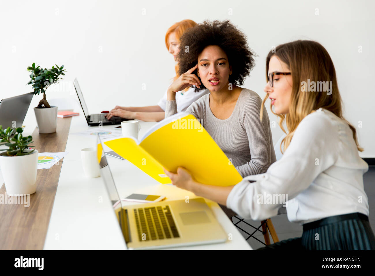 Young women working in the office Stock Photo - Alamy