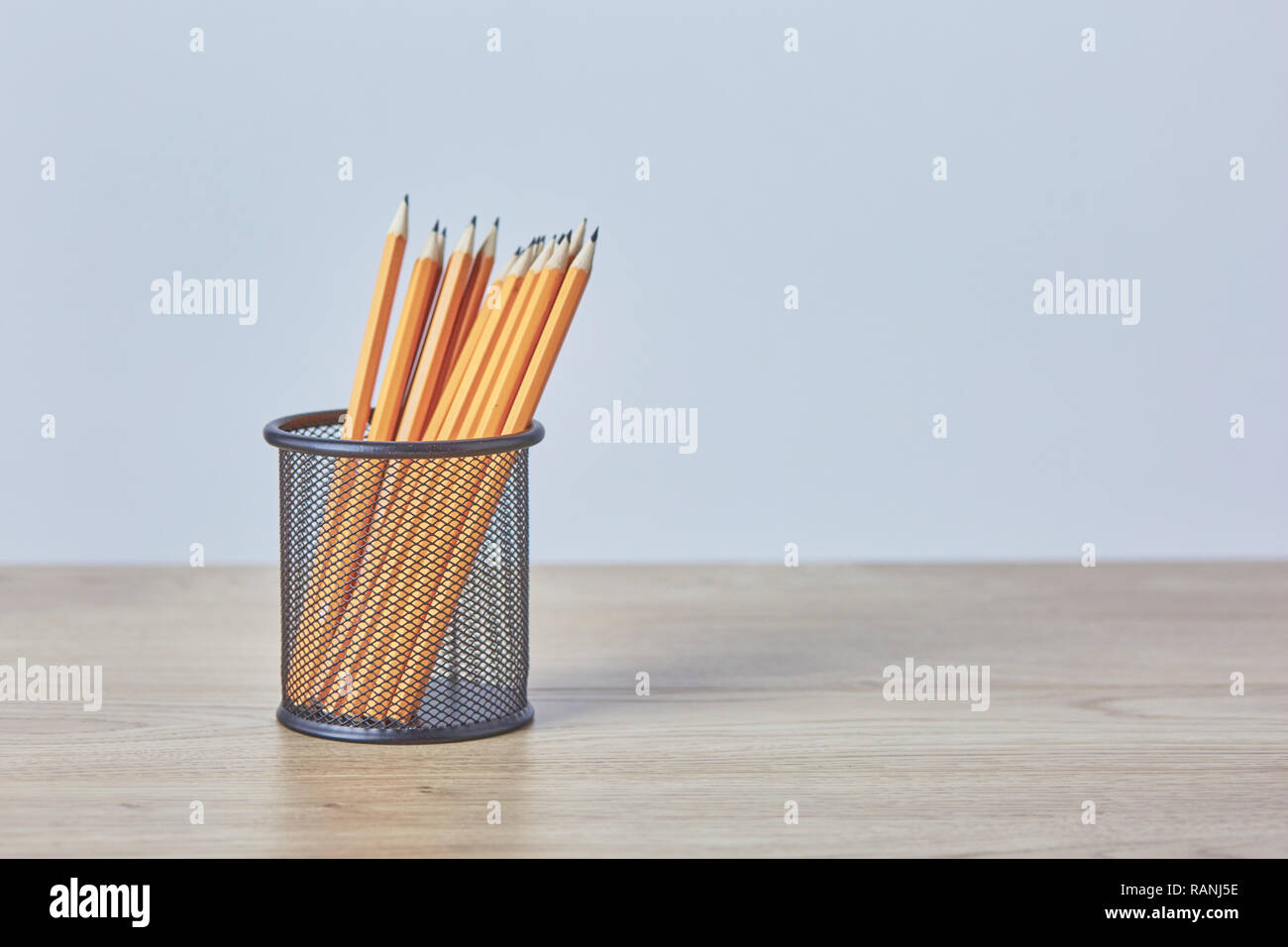 Graphite pencils in a metal grid-container. Concept Stock Photo - Alamy